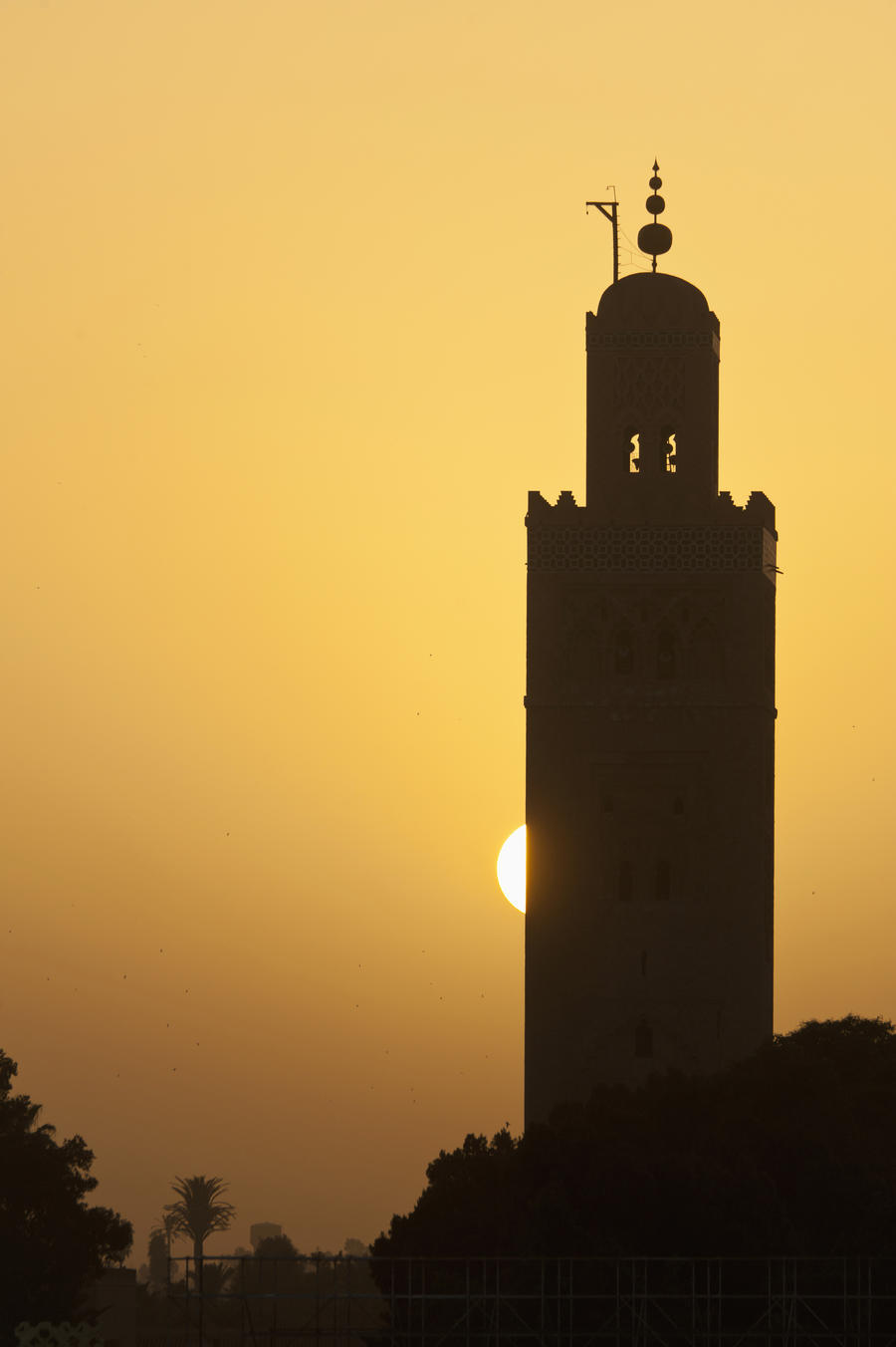 Morocco, Sun setting behind minaret of Koutoubia mosque; Marrakesh by ...