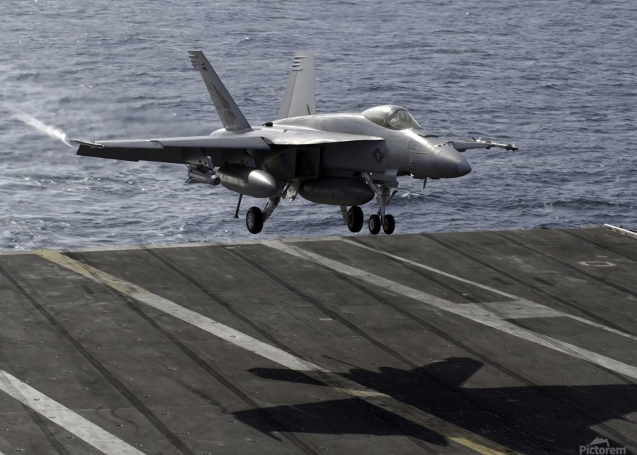 An F-A-18E Super Hornet prepares to land on the flight deck aboard USS ...