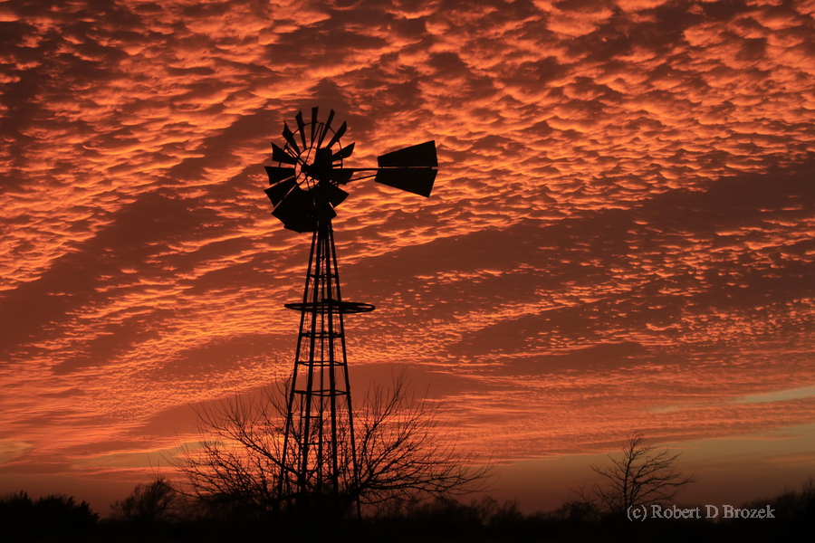 Kansas Sunset with a red sky with clouds and a Windmill silhouette by ...