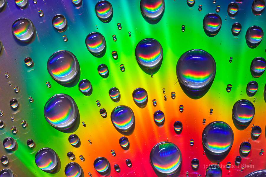 Brilliant rainbow of colors on metallic surface and inside water by ...
