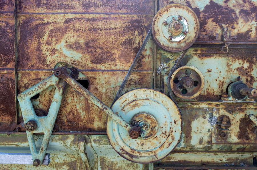 Rusty machine gears pulleys and belt by David Reinhold Wall Art