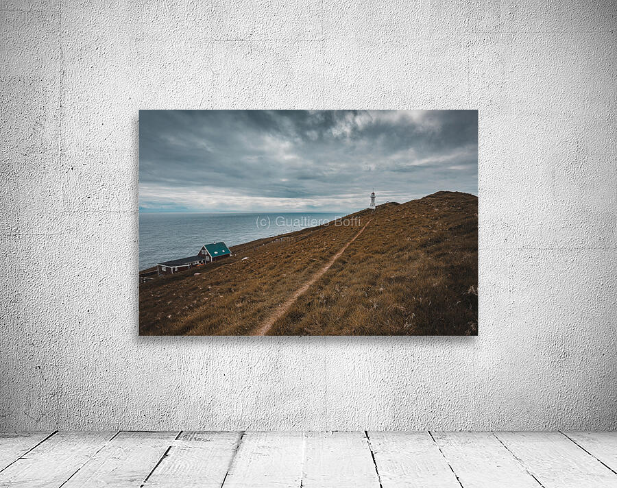 lighthouse on the island of Mykines Faroe. by Gualtiero Boffi Wall Art